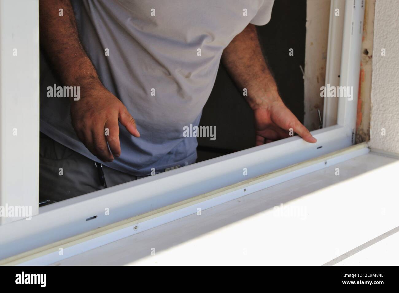 Professional window installation by a craftsman Stock Photo - Alamy