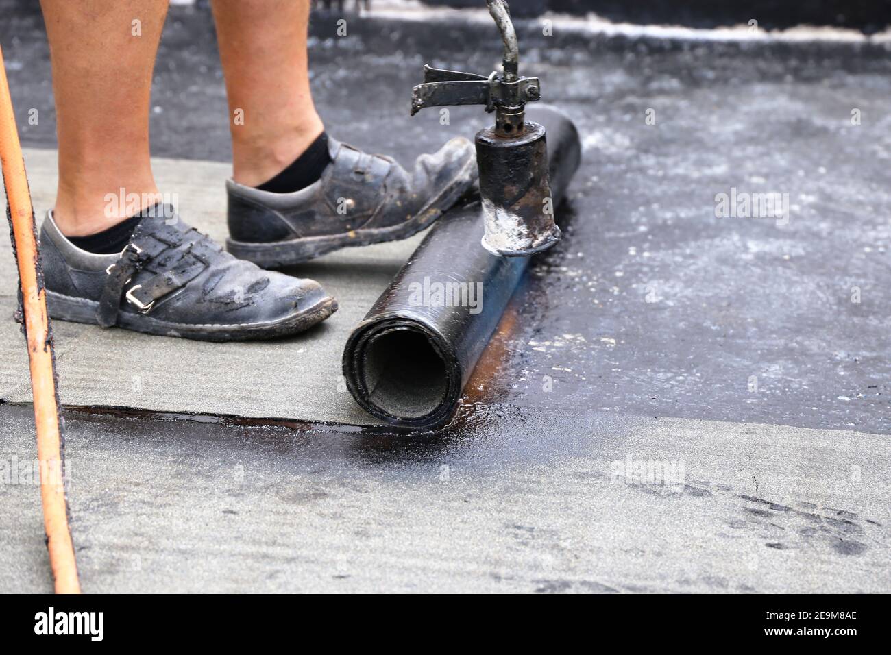 Professional flat roof waterproofing with bitumen welded sheeting Stock Photo - Alamy