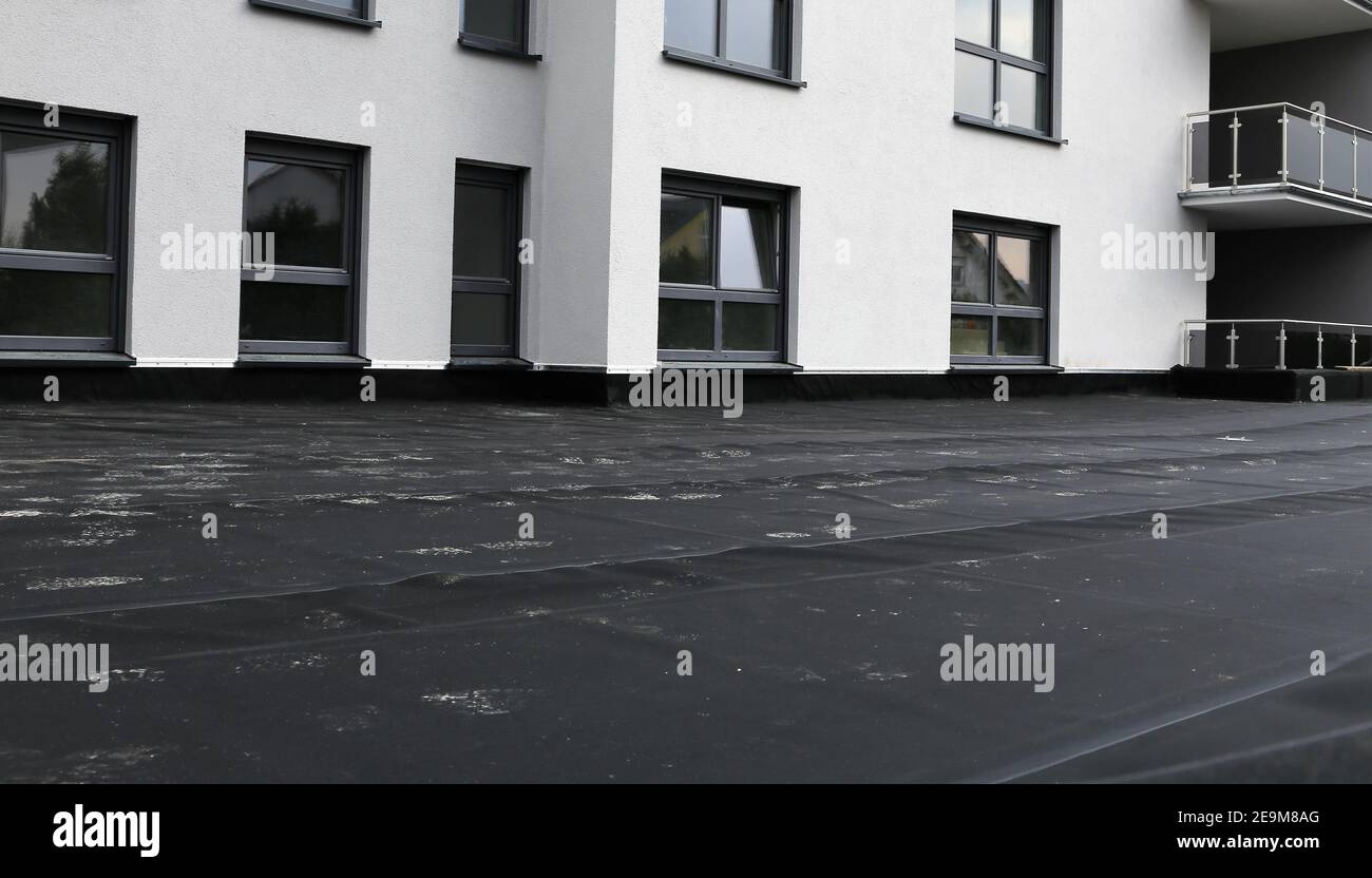 Professional flat roof waterproofing with bitumen welded sheeting Stock Photo - Alamy