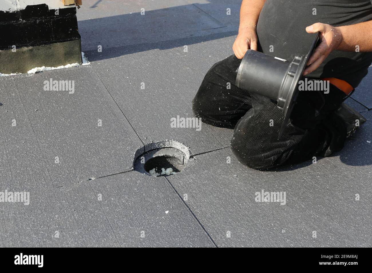 Installation of gradient insulation on a flat roof Stock Photo - Alamy