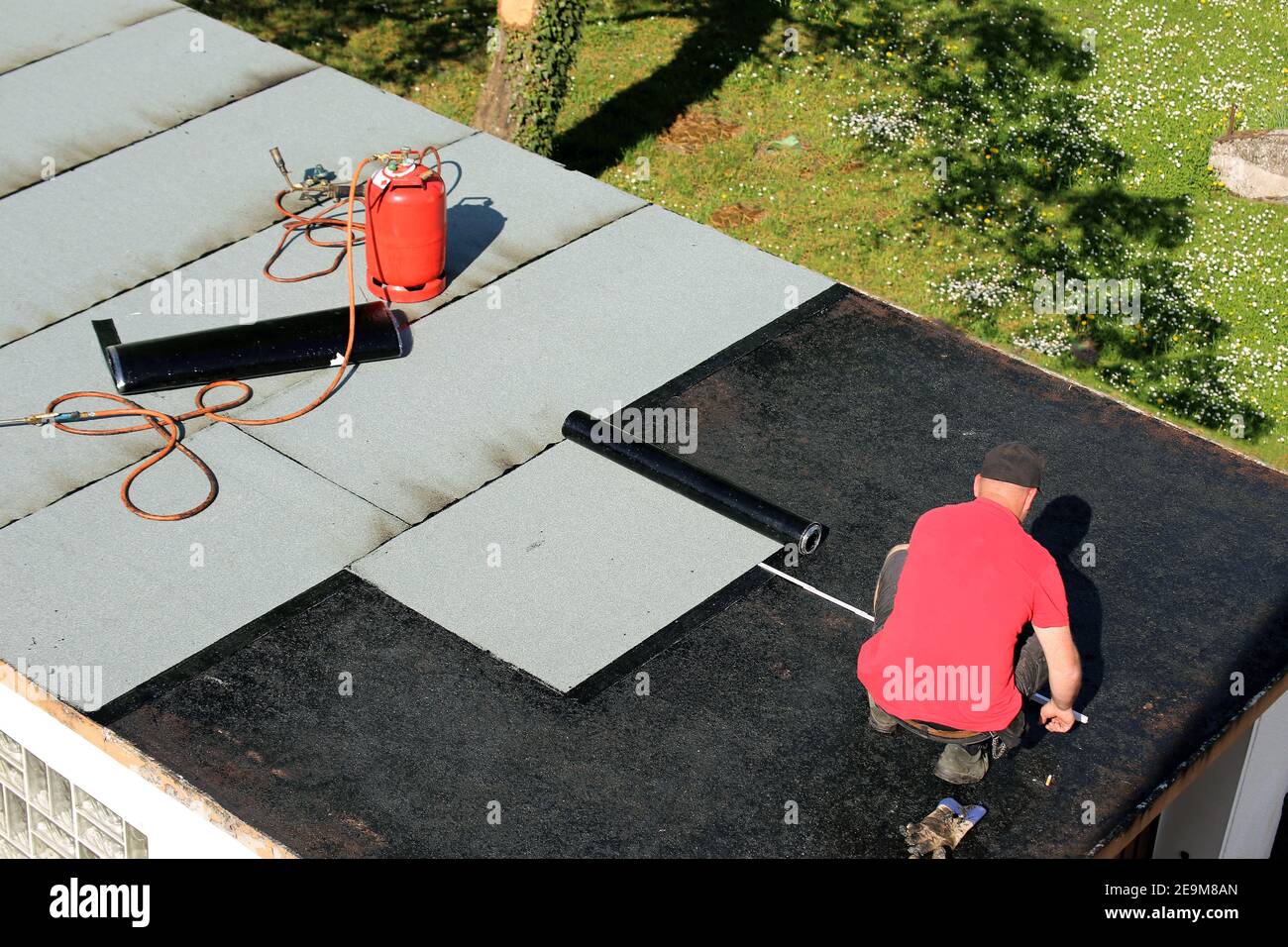 Professional flat roof waterproofing with bitumen welded sheeting Stock Photo - Alamy
