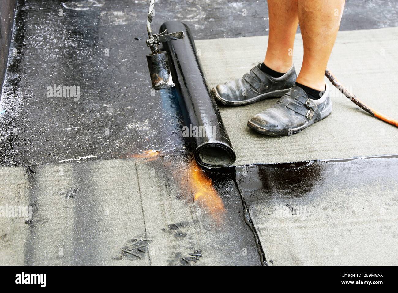 Professional flat roof waterproofing with bitumen welded sheeting Stock Photo - Alamy