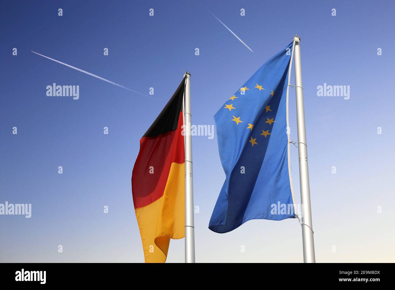 German and european flag in front of a blue sky Stock Photo - Alamy