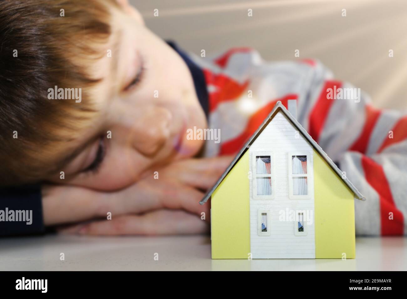 Symbol image: Boy looks longingly at a model house (model released ...