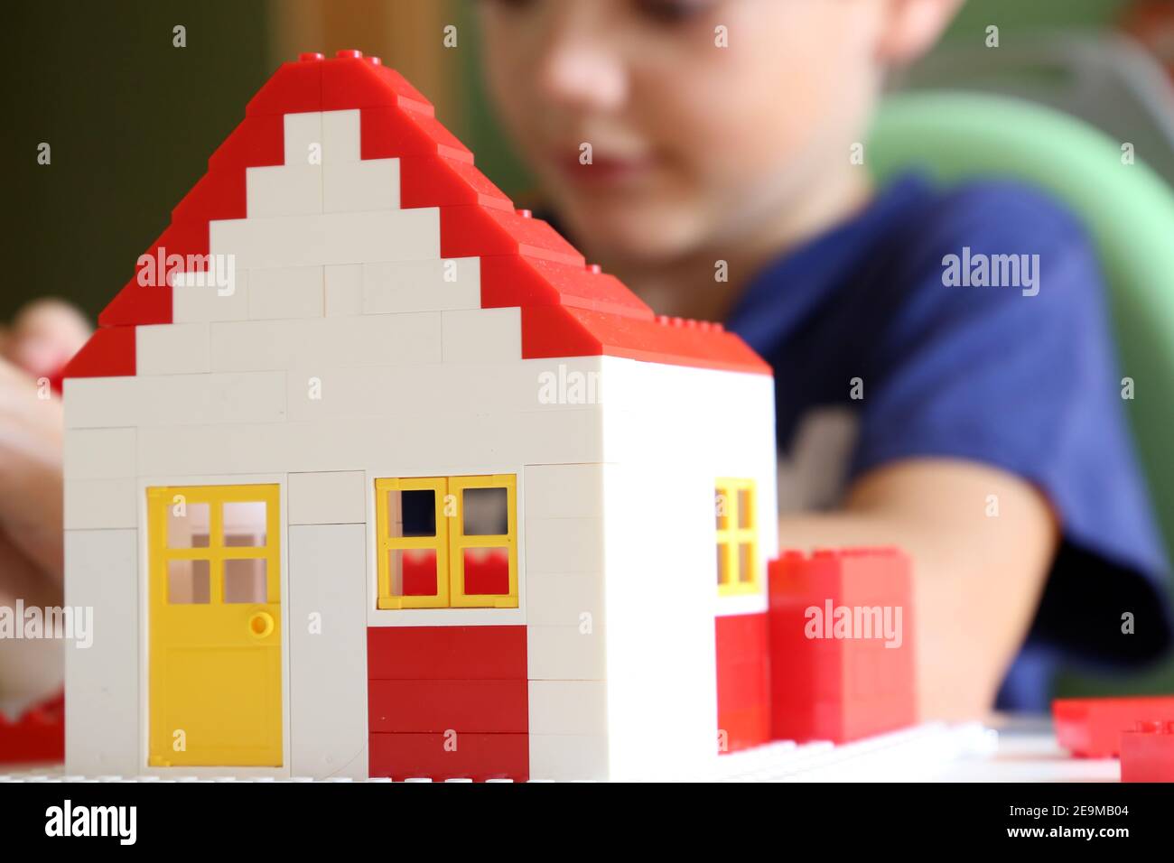 Symbol image: Boy builds a house with building blocks (Model released ...