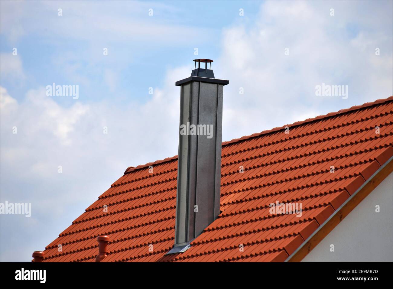 Chimney with stainless steel cladding on a newly covered roof Stock ...
