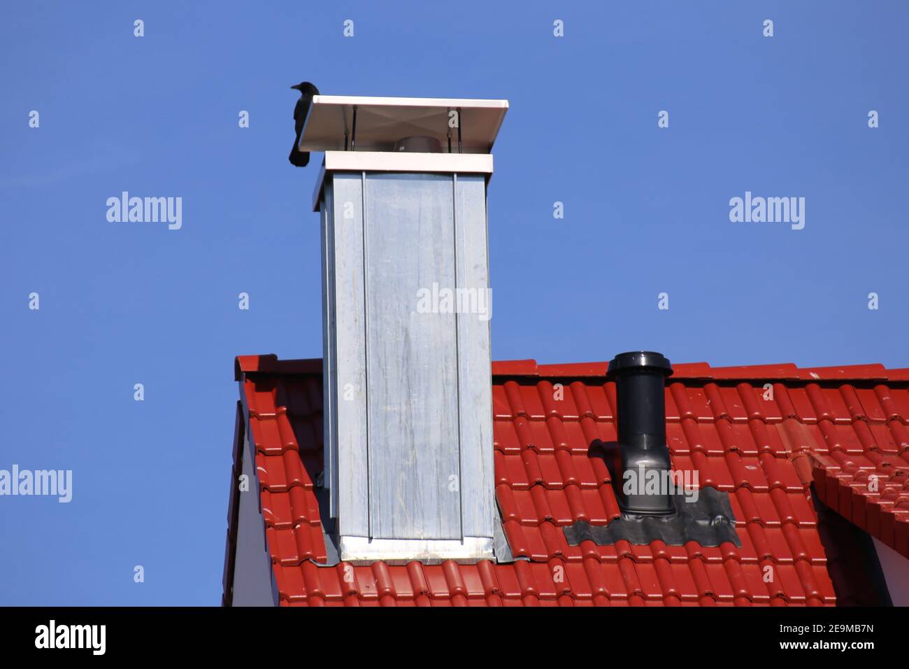 Chimney with stainless steel cladding on a newly covered roof Stock ...