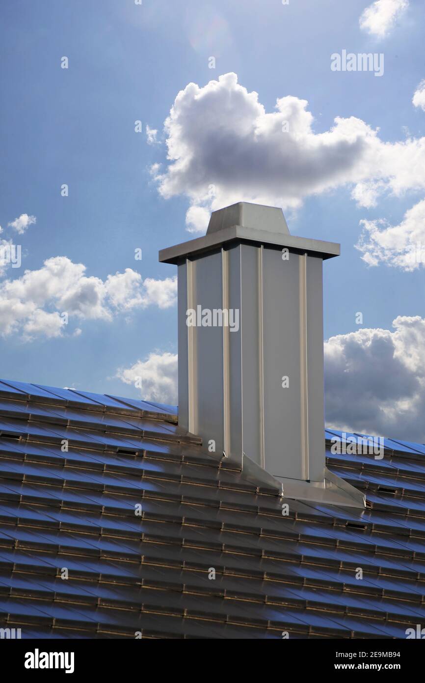 Chimney with stainless steel cladding on a newly covered roof Stock ...