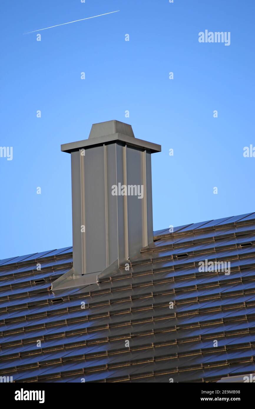 Chimney with stainless steel cladding on a newly covered roof Stock ...