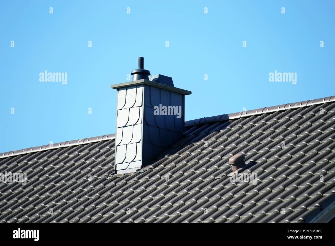 New tiled roof with slate cladded chimney Stock Photo - Alamy
