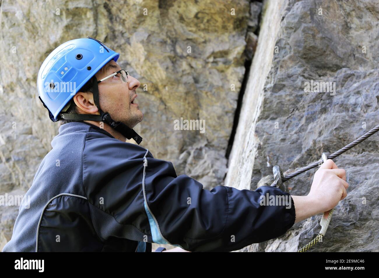 Man climbing via ferrata Stock Photo - Alamy