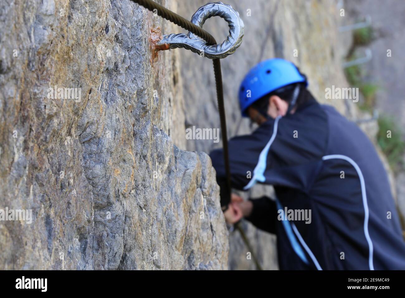Man climbing via ferrata Stock Photo - Alamy