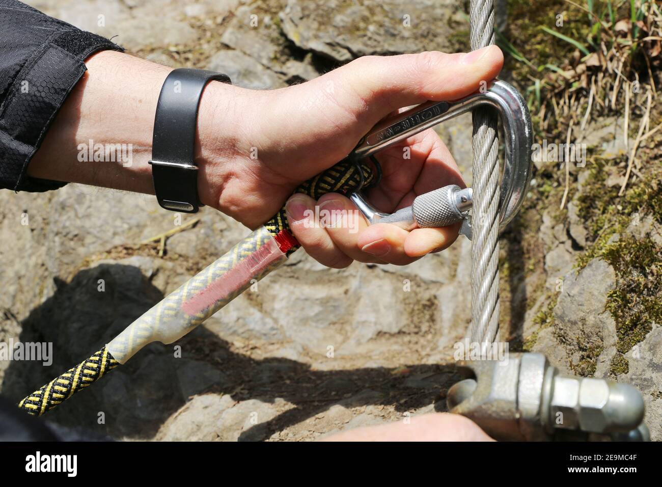 Man climbing via ferrata Stock Photo - Alamy