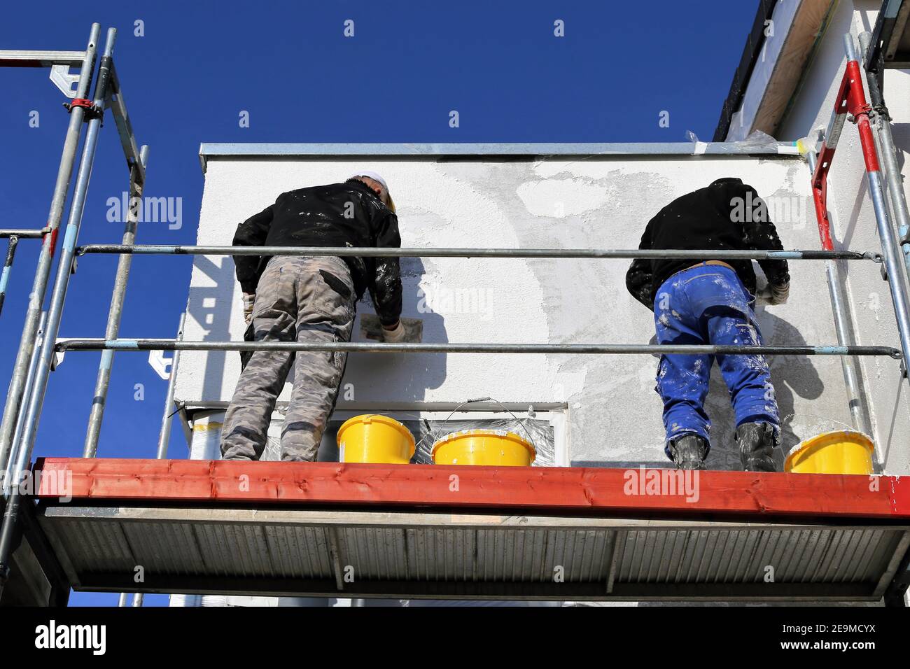 Painter painting the facade of a new residential building Stock Photo ...