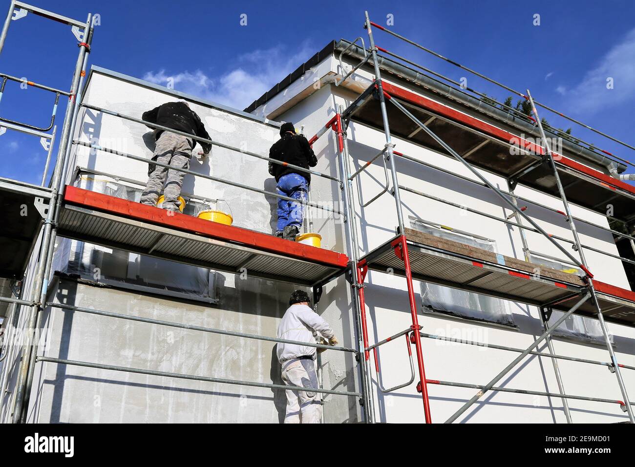 Painter painting the facade of a new residential building Stock Photo ...