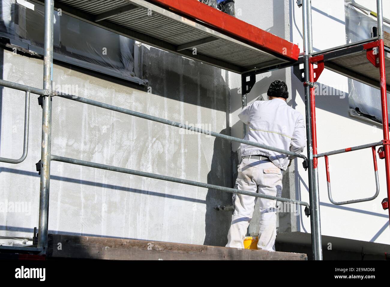 Painter painting the facade of a new residential building Stock Photo ...