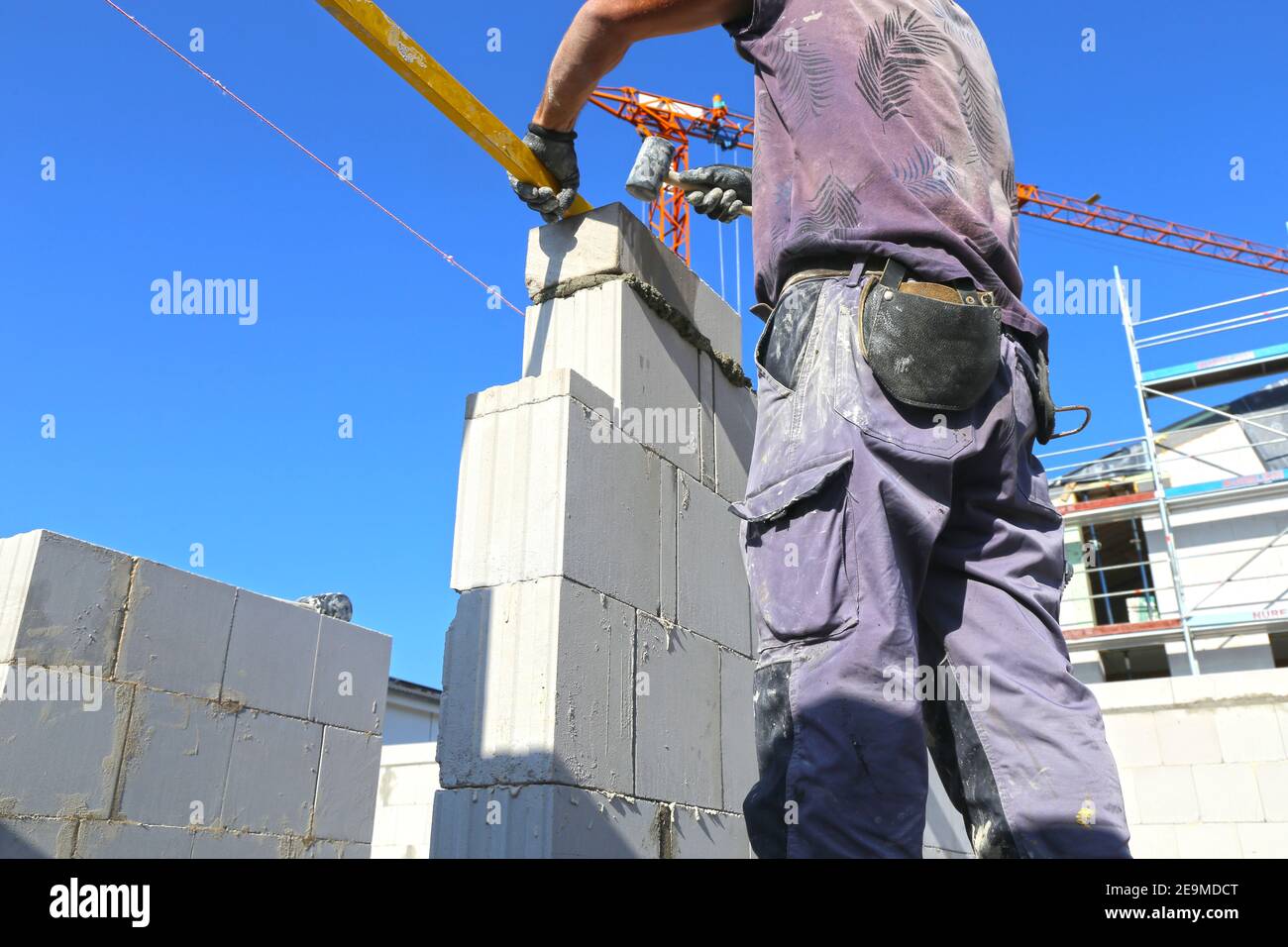 Construction worker (bricklayer) works on the construction site Stock ...