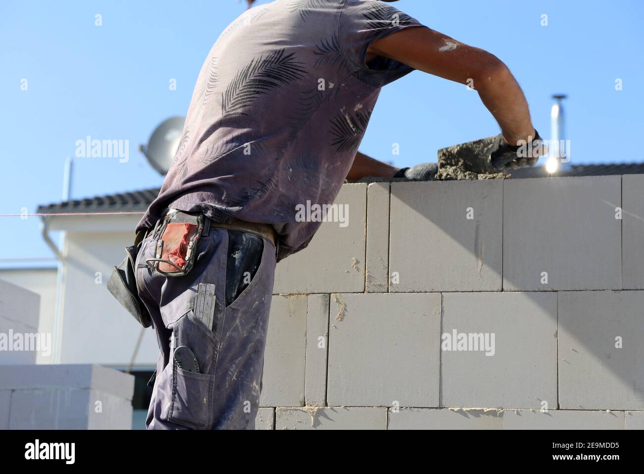 Construction worker (bricklayer) works on the construction site Stock ...