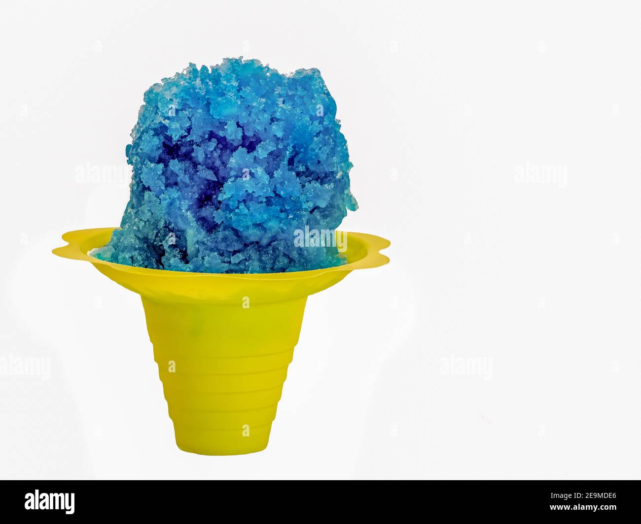 Blue Hawaiian style shave ice, shaved ice or a snow cone in a yellow ...