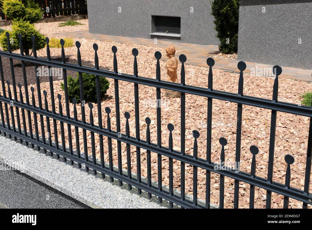 New high quality metal fence on the front yard of a residential house ...