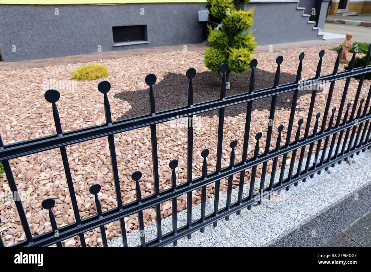 New high quality metal fence on the front yard of a residential house ...