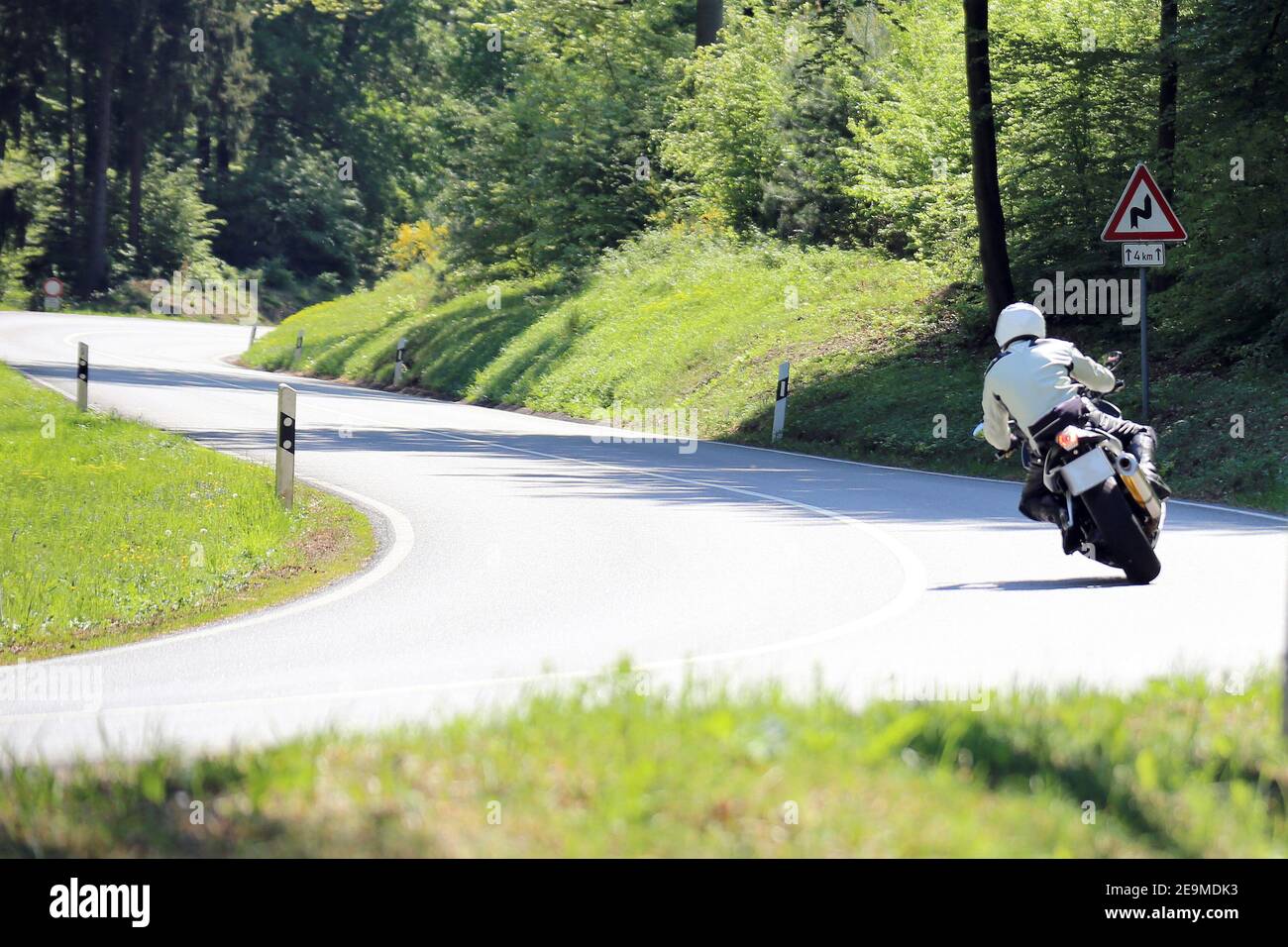 Sporty motorcyclist photographed from behind Stock Photo - Alamy