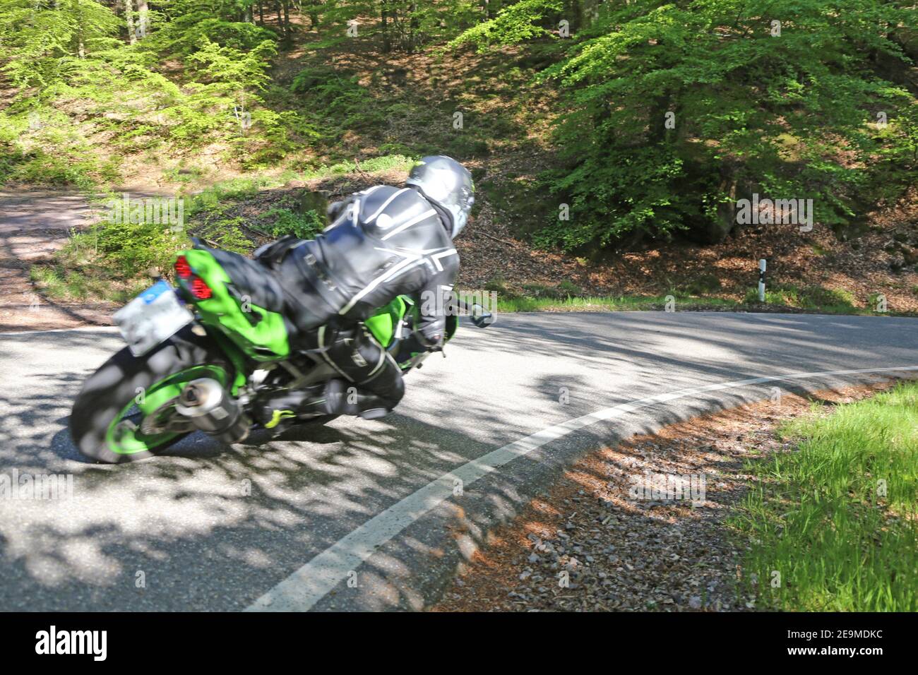 Sporty motorcyclist photographed from behind Stock Photo - Alamy