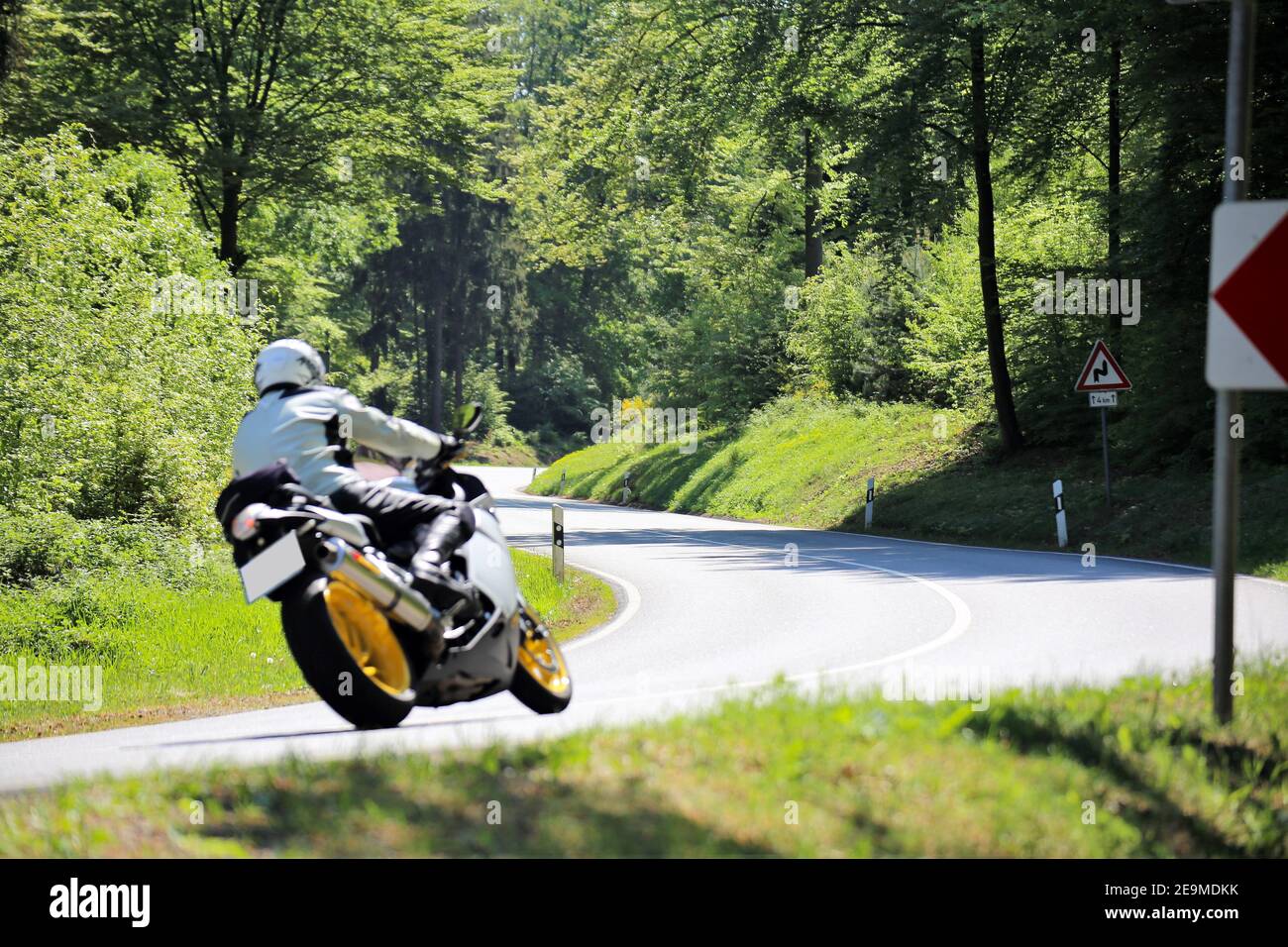 Sporty motorcyclist photographed from behind Stock Photo - Alamy