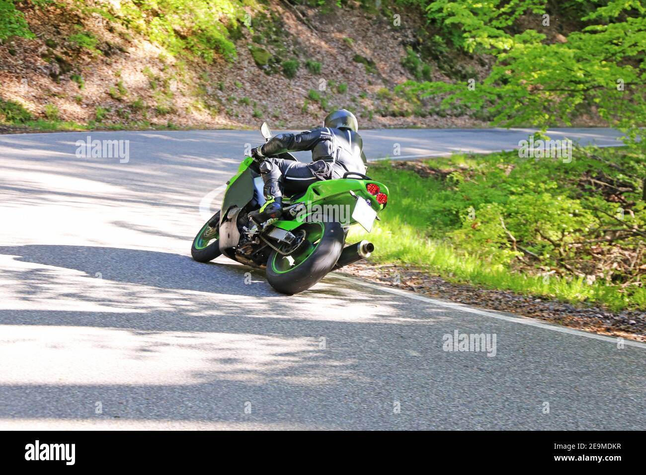 Sporty motorcyclist photographed from behind Stock Photo - Alamy
