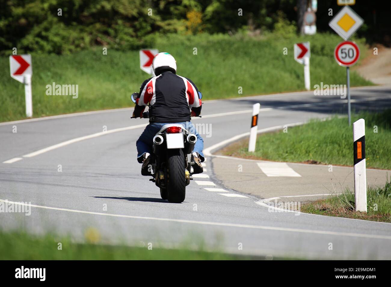 Sporty motorcyclist photographed from behind Stock Photo - Alamy