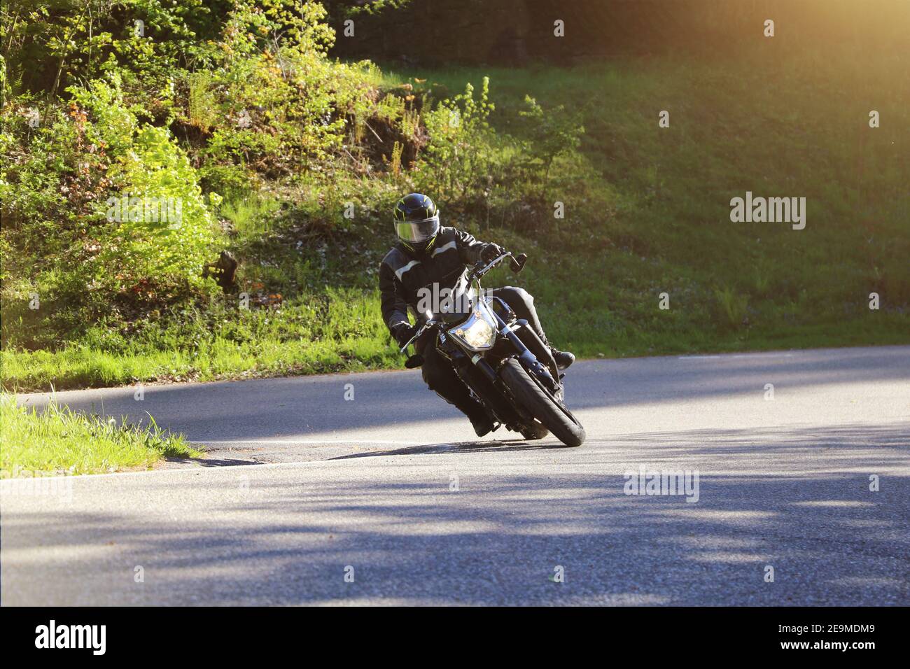 Sporting motorcyclist on a country road, Germany (model released Stock ...