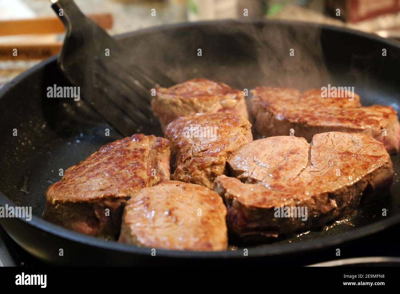 Beef fillet (beef tenderloin) grilling in the frying pan Stock Photo ...