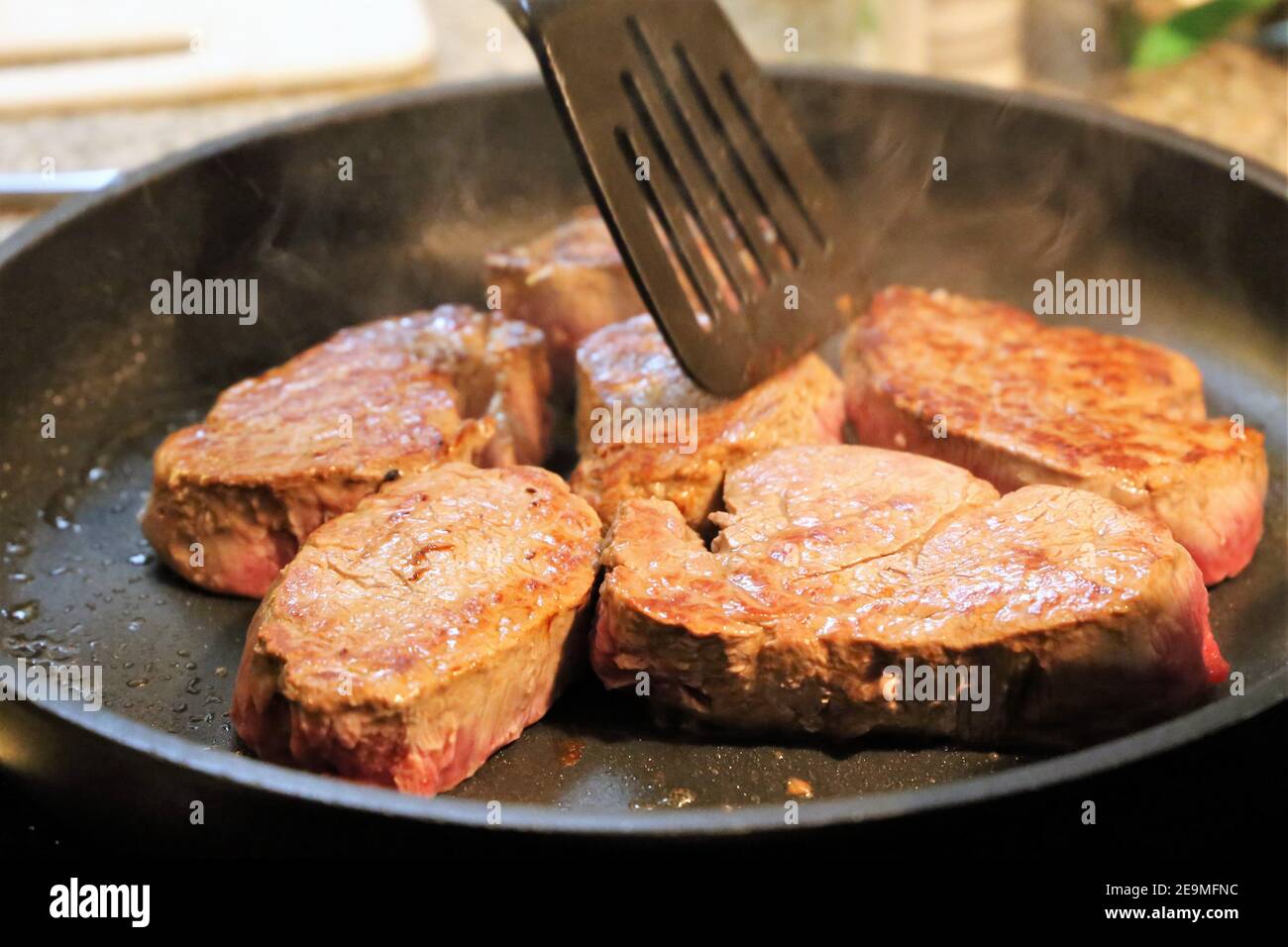 Beef fillet (beef tenderloin) grilling in the frying pan Stock Photo ...