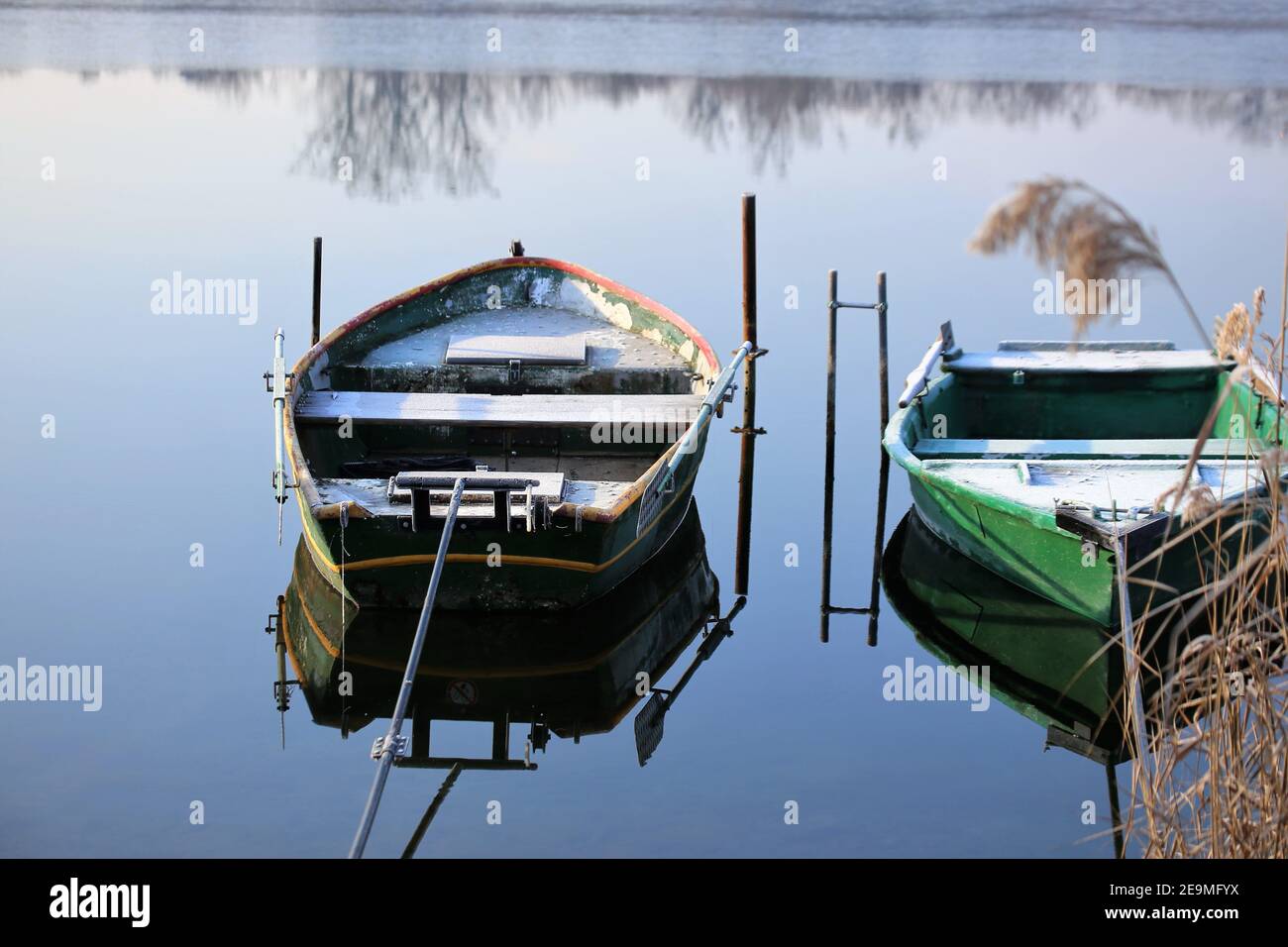Symbol image: Moored rowing boats in winter Stock Photo - Alamy