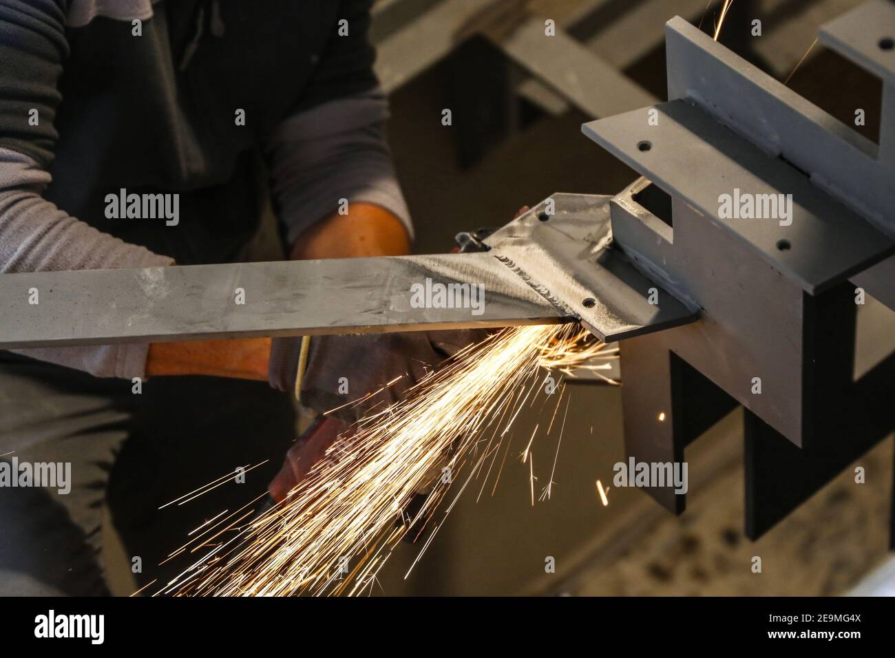 Grinding work, the sparks are spraying Stock Photo - Alamy