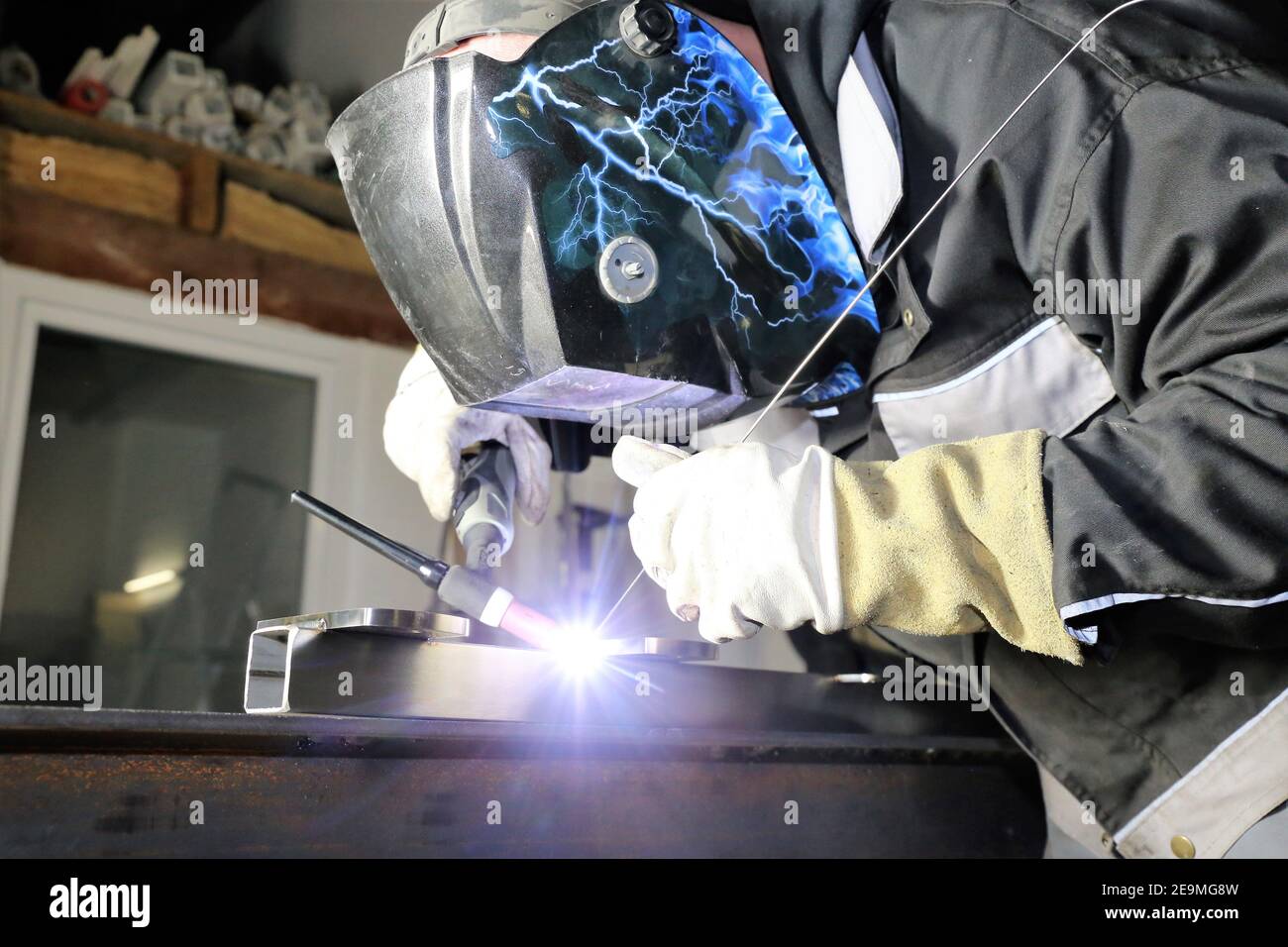 Metal worker doing welding work in his workshop Stock Photo - Alamy