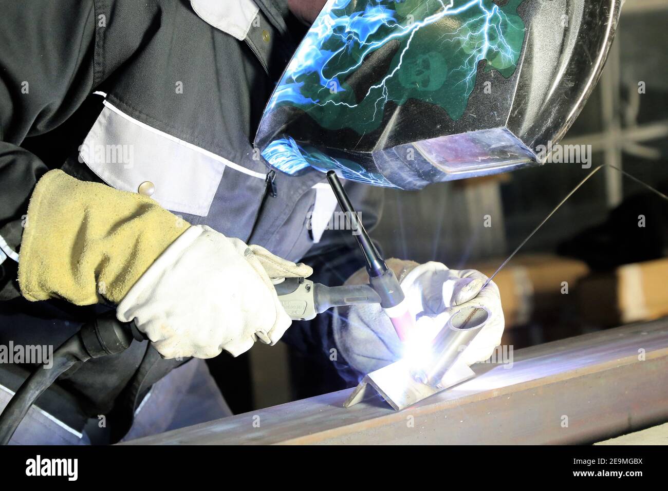 Metal worker doing welding work in his workshop Stock Photo - Alamy