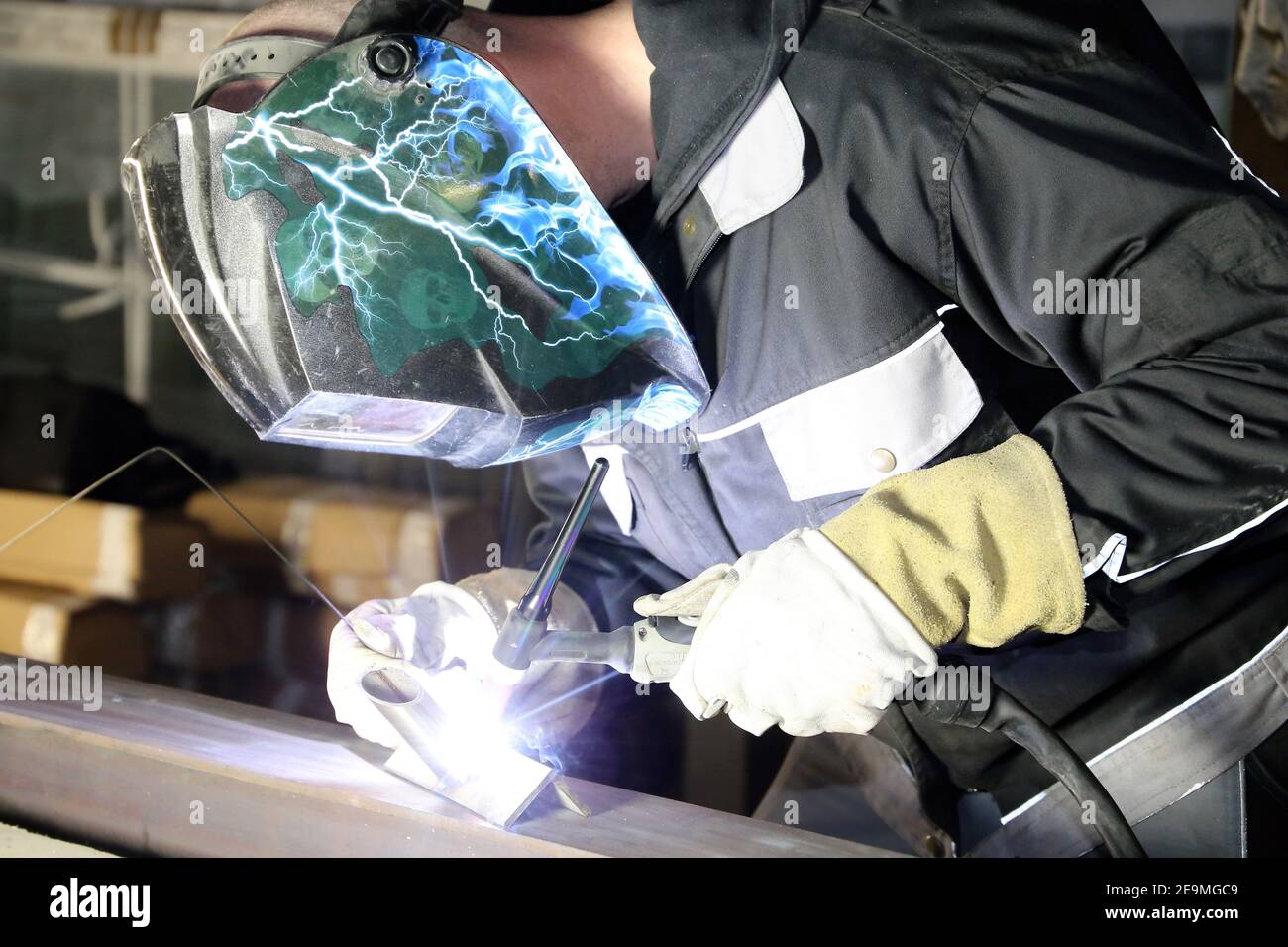 Metal worker doing welding work in his workshop Stock Photo - Alamy