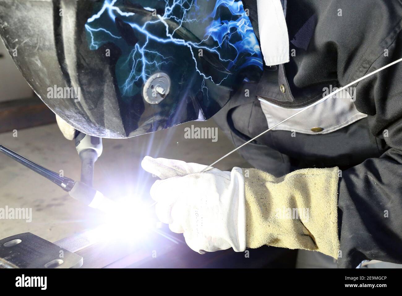 Metal worker doing welding work in his workshop Stock Photo - Alamy