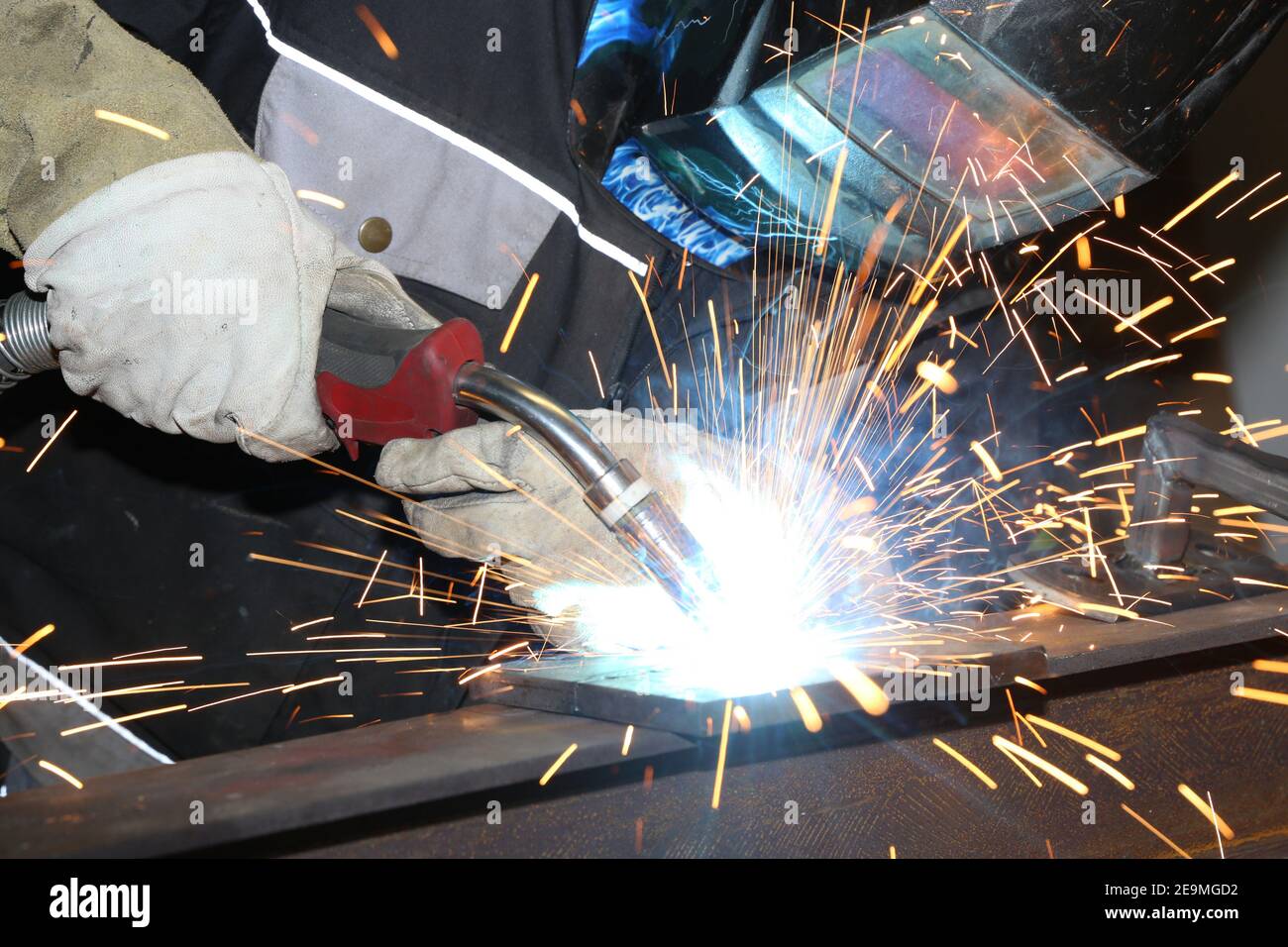 Metal worker doing welding work in his workshop Stock Photo - Alamy