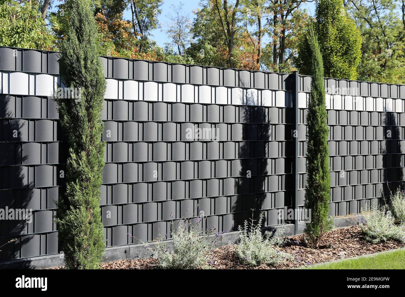 Modern new privacy fence as a boundary of the property Stock Photo - Alamy