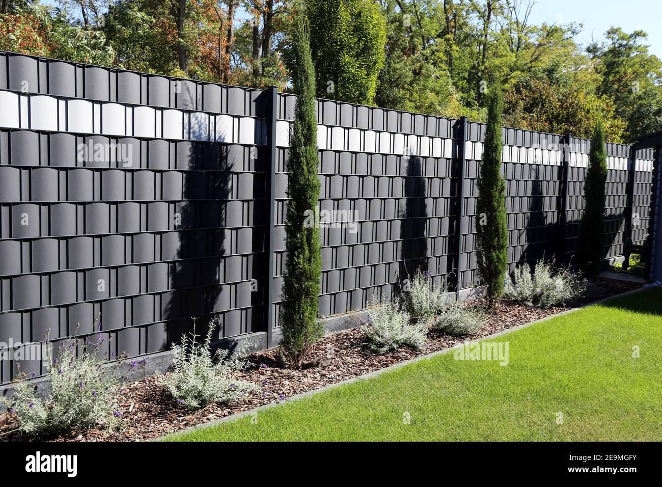 Modern new privacy fence as a boundary of the property Stock Photo - Alamy
