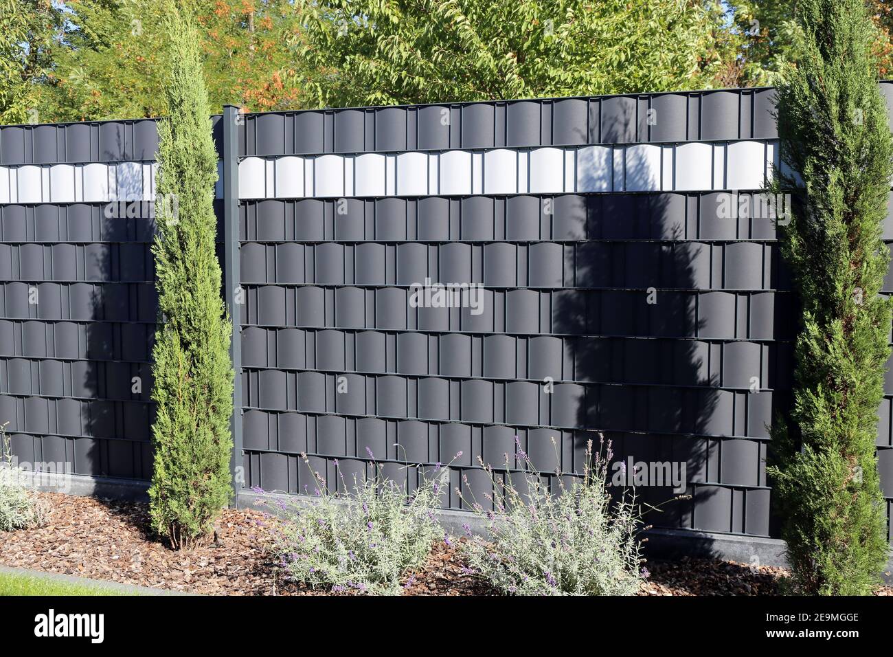 Modern new privacy fence as a boundary of the property Stock Photo - Alamy