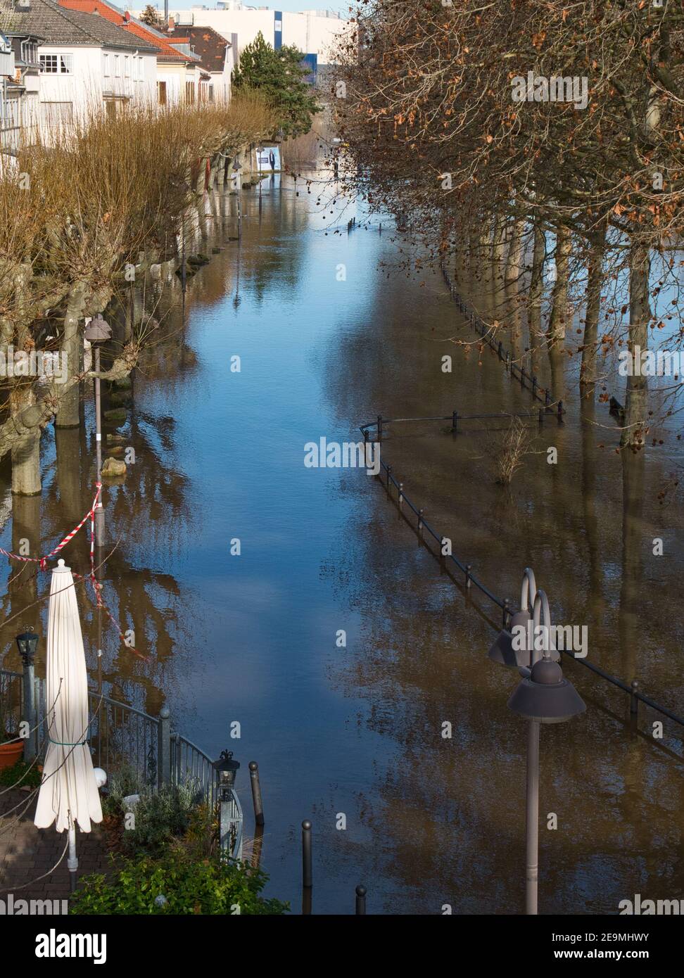 A railing of street lamps, trees and a handrail line protrude from the ...