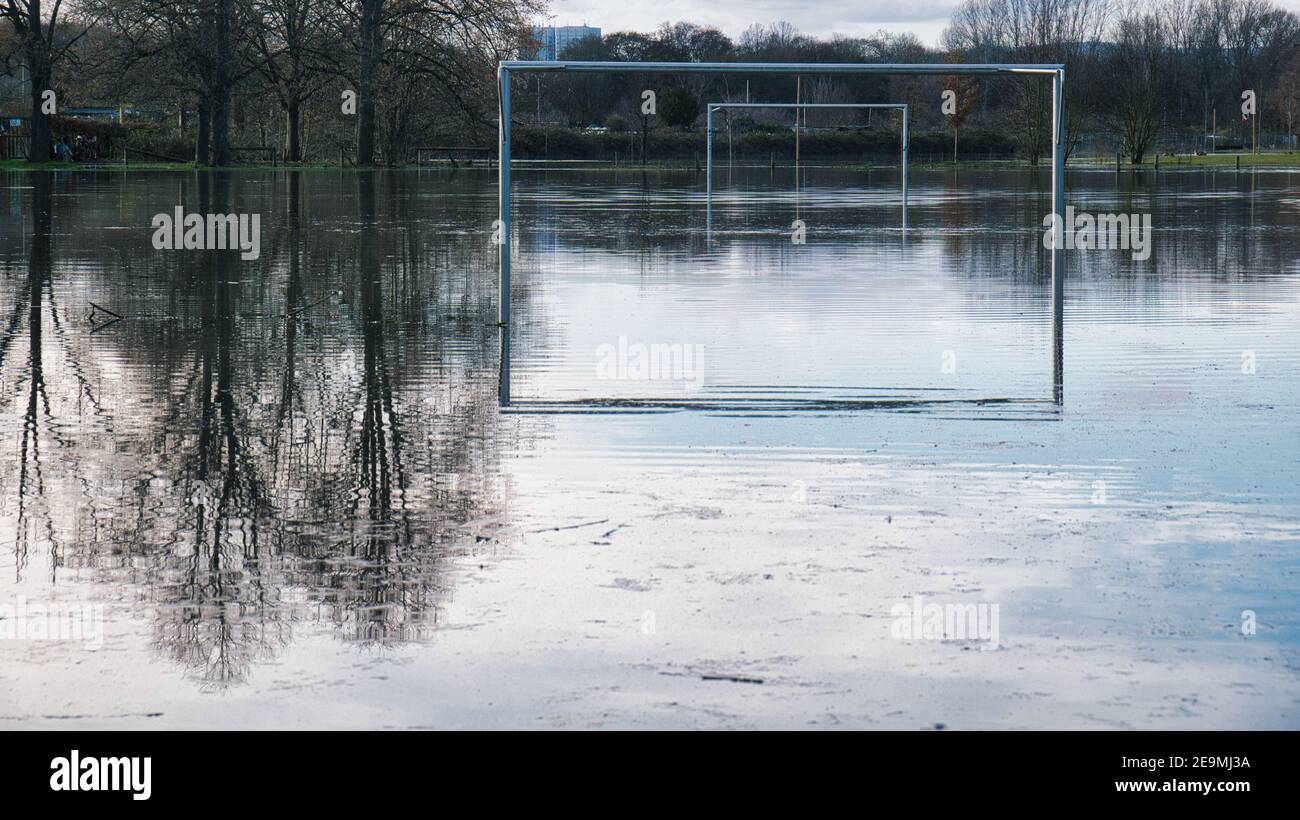 Flooded soccer football field with reflections of the goals in standing ...