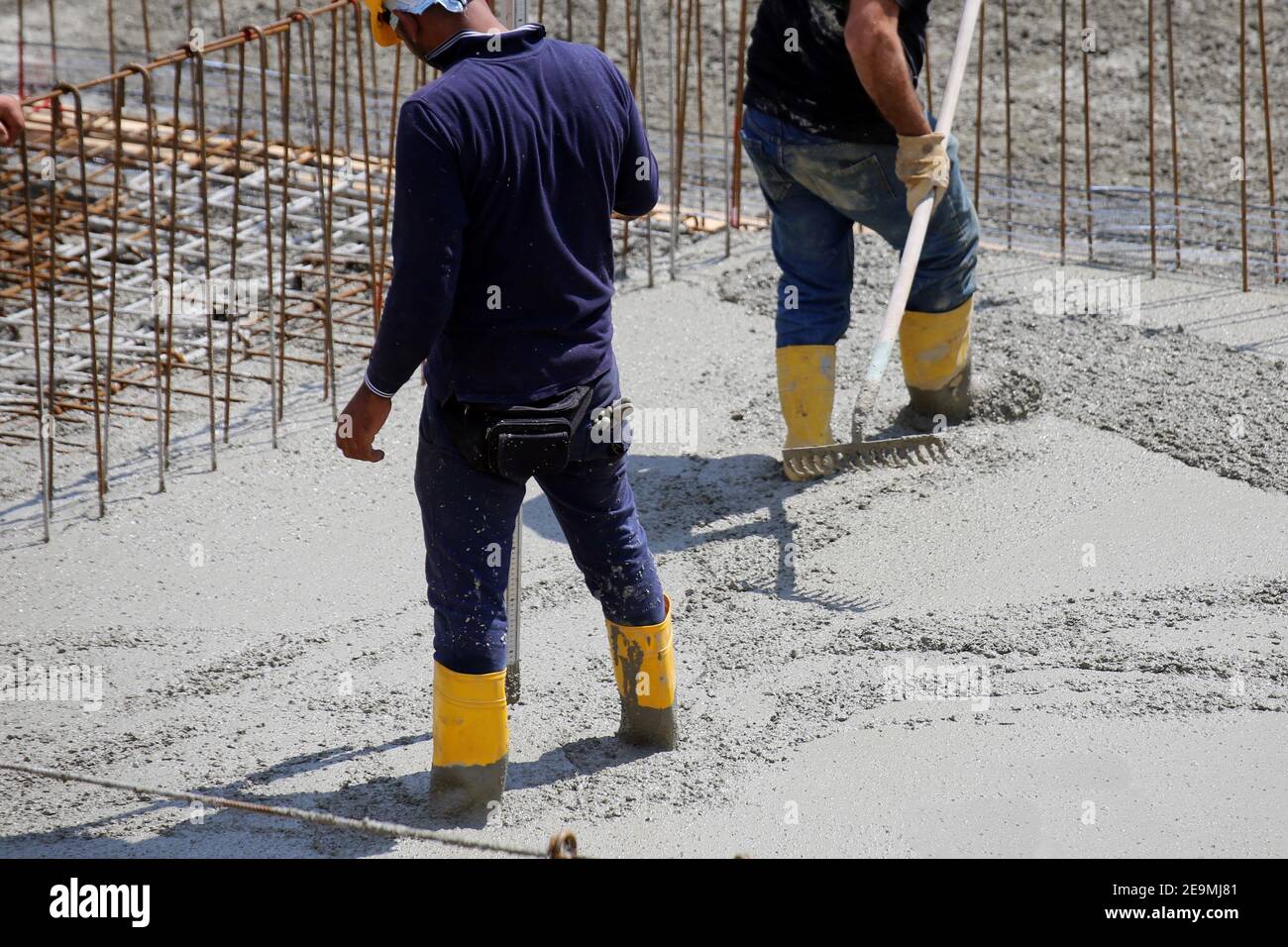 Concreting a base plate with ready-mixed concrete on the construction ...
