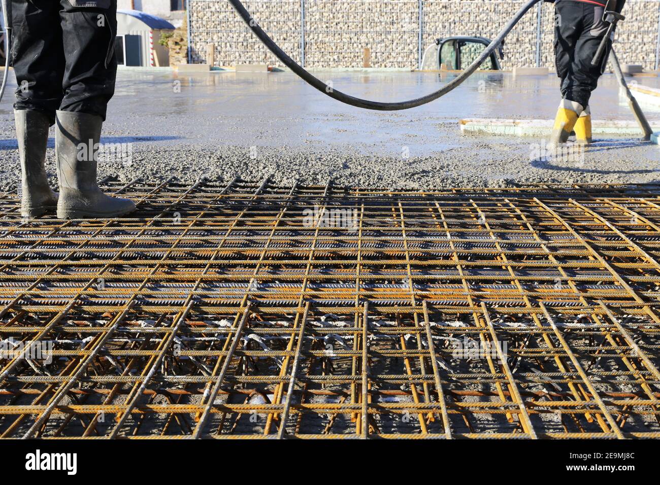 Concreting a base plate with ready-mixed concrete on the construction ...