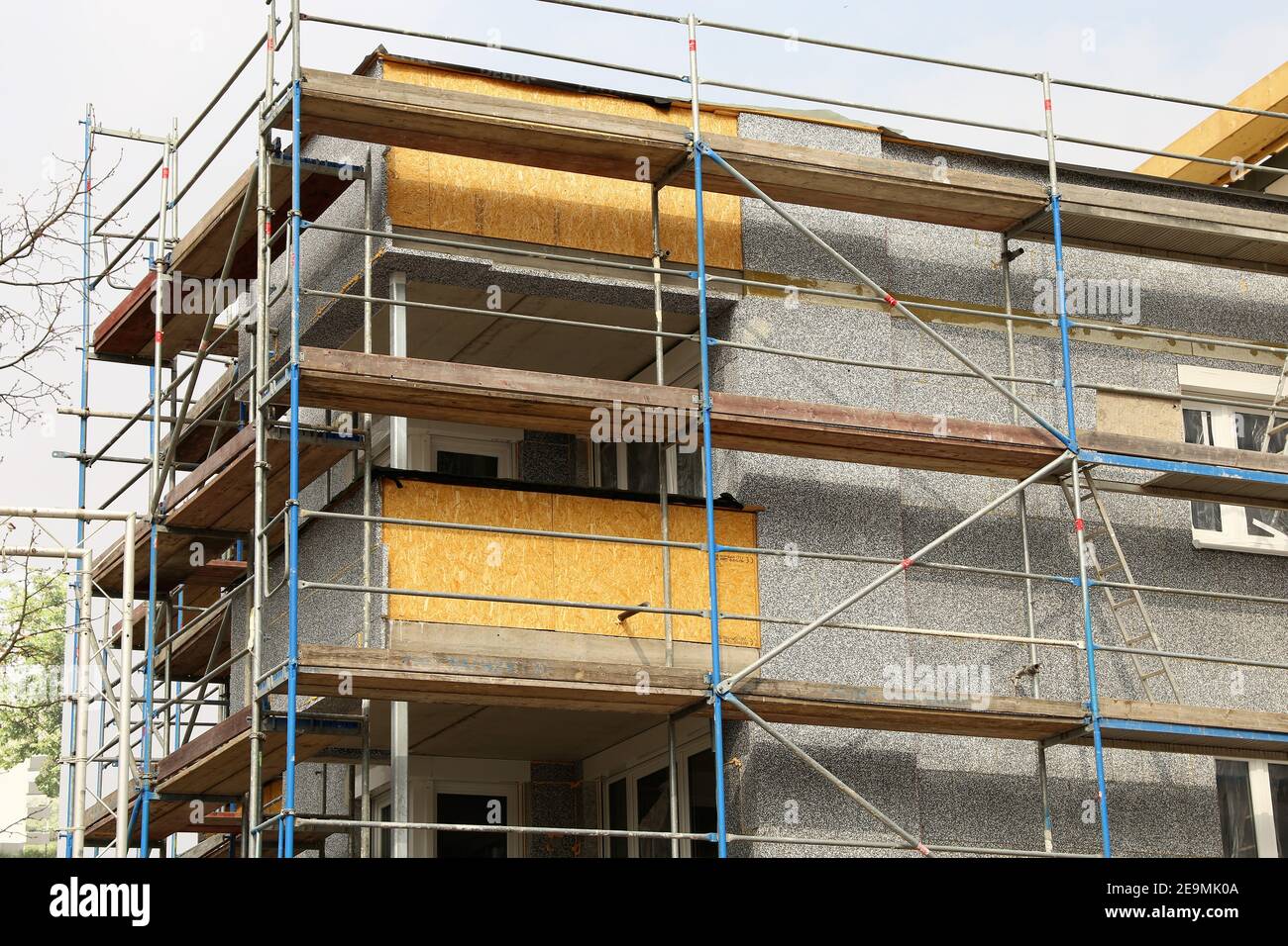 Installation of thermal insulation to a house facade Stock Photo - Alamy
