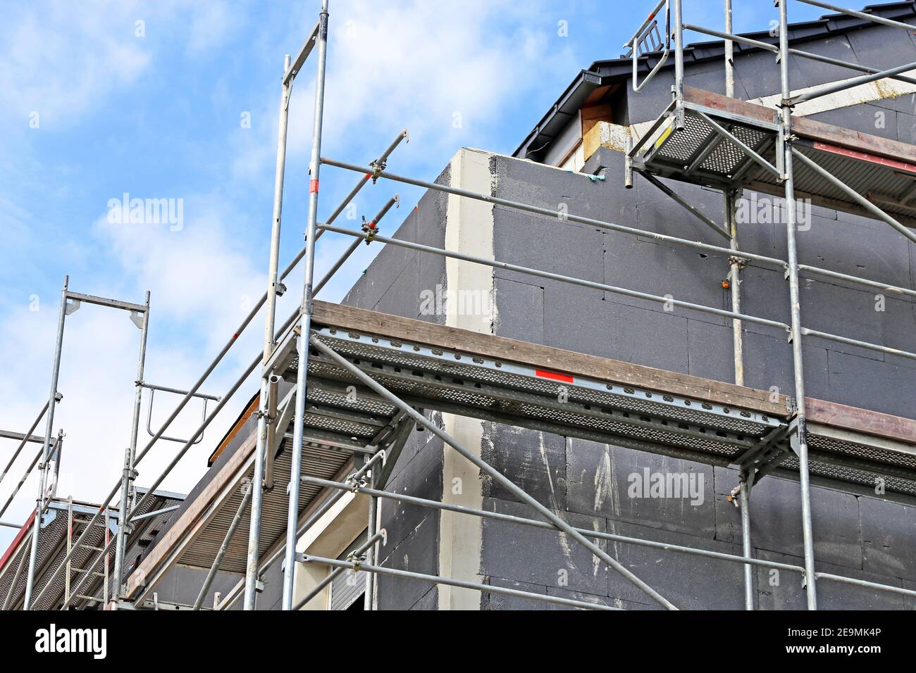 Installation of thermal insulation to a house facade Stock Photo - Alamy