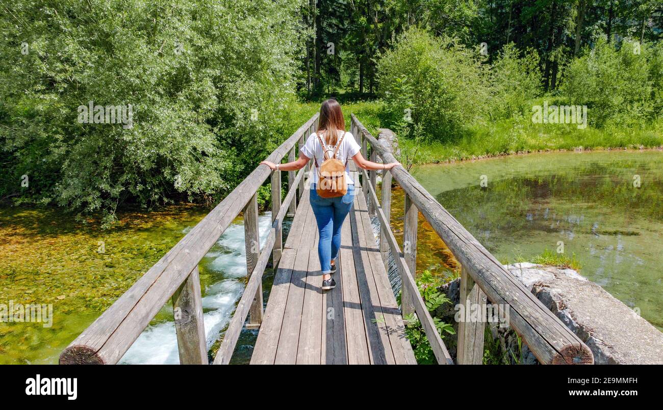 Back woman backpack wood bridge hi-res stock photography and images - Alamy